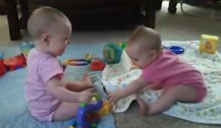 Twin babies are pure joy playing keep away with toy