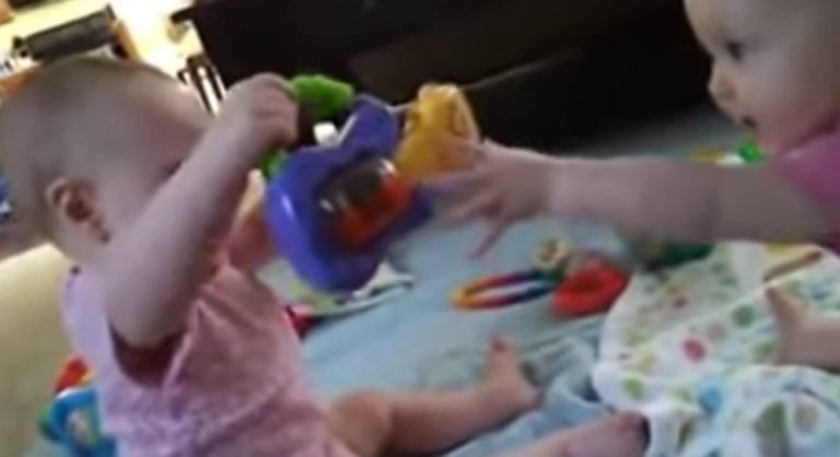 Twin babies are pure joy playing keep away with toy