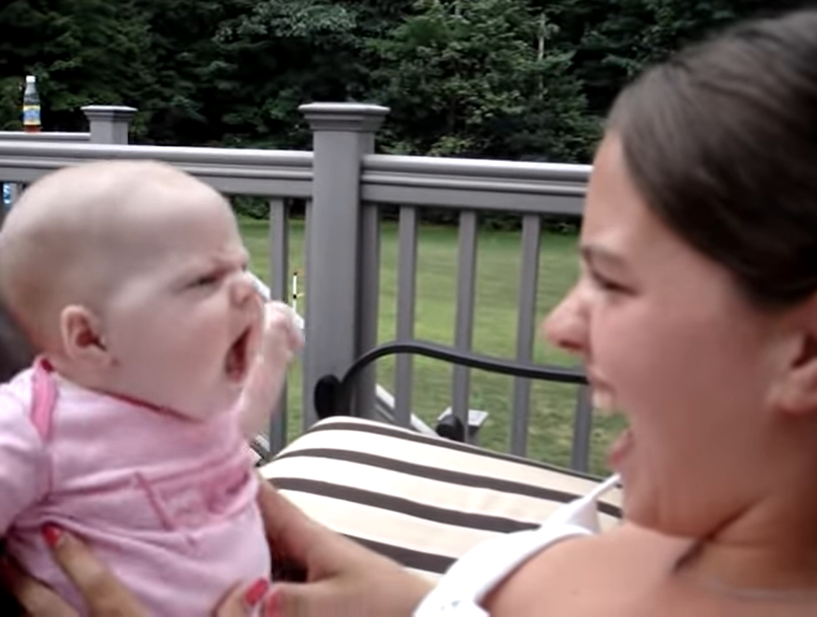 Funny baby girl growls at auntie