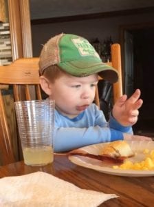 Funny little boy shows how to give directions in the country