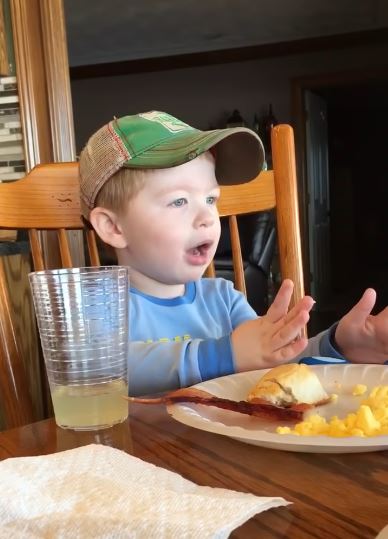 Funny little boy shows how to give directions in the country