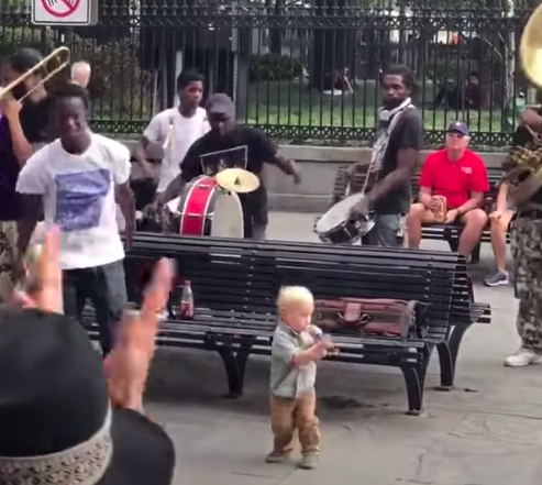 Toddler Steals Show From Street Performer With Trumpet And Dance