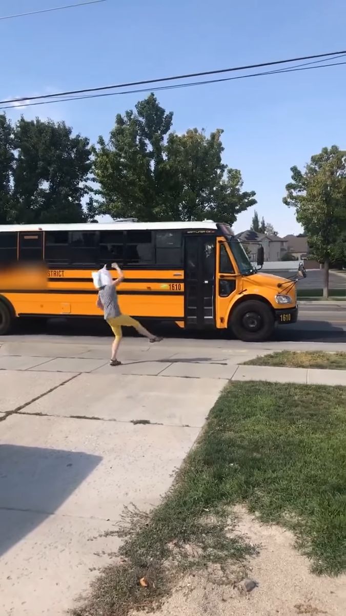 Mom waits for school bus in her best outfit