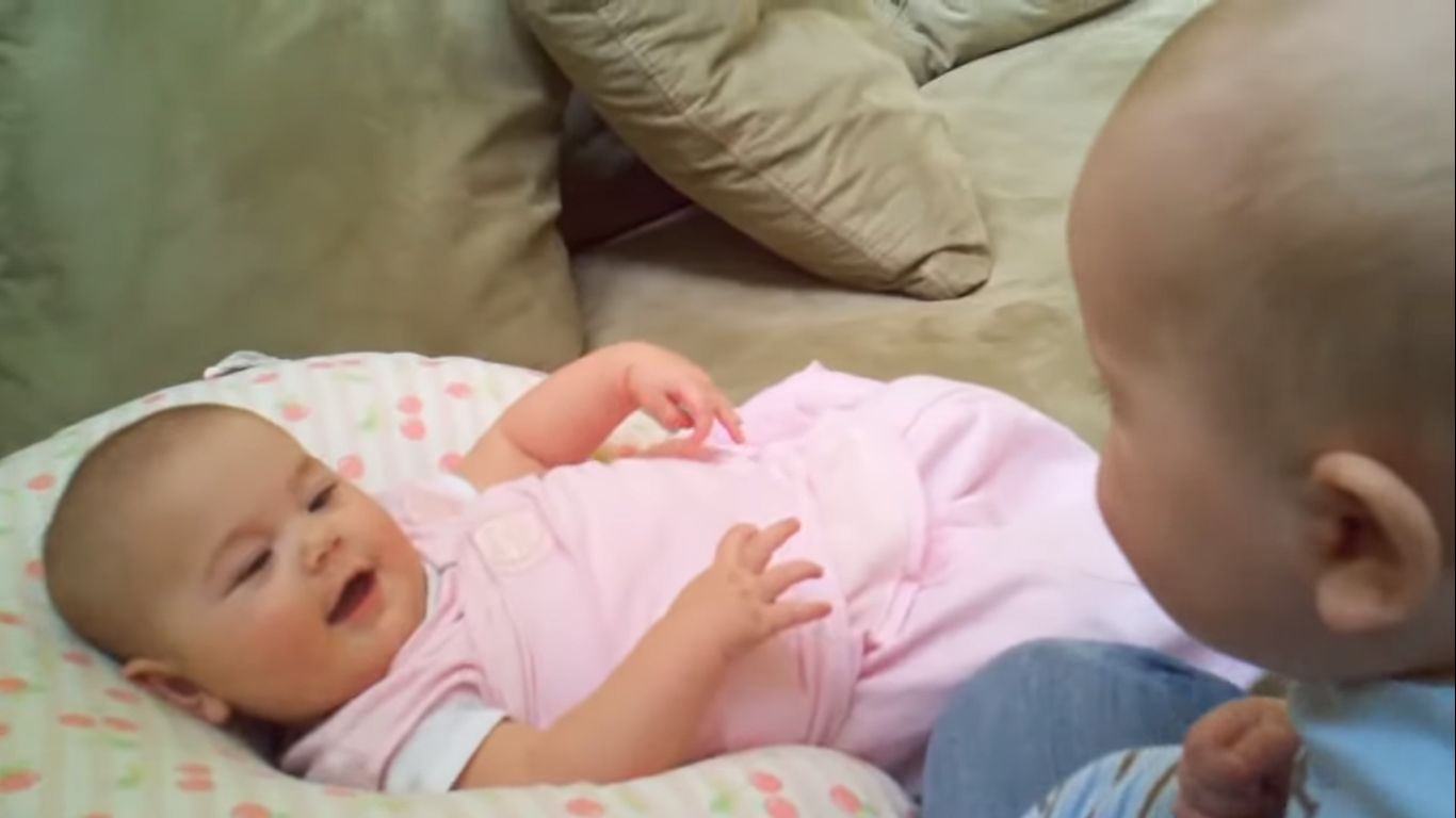 Twin babies break out in nonstop giggles when they finally notice each ...