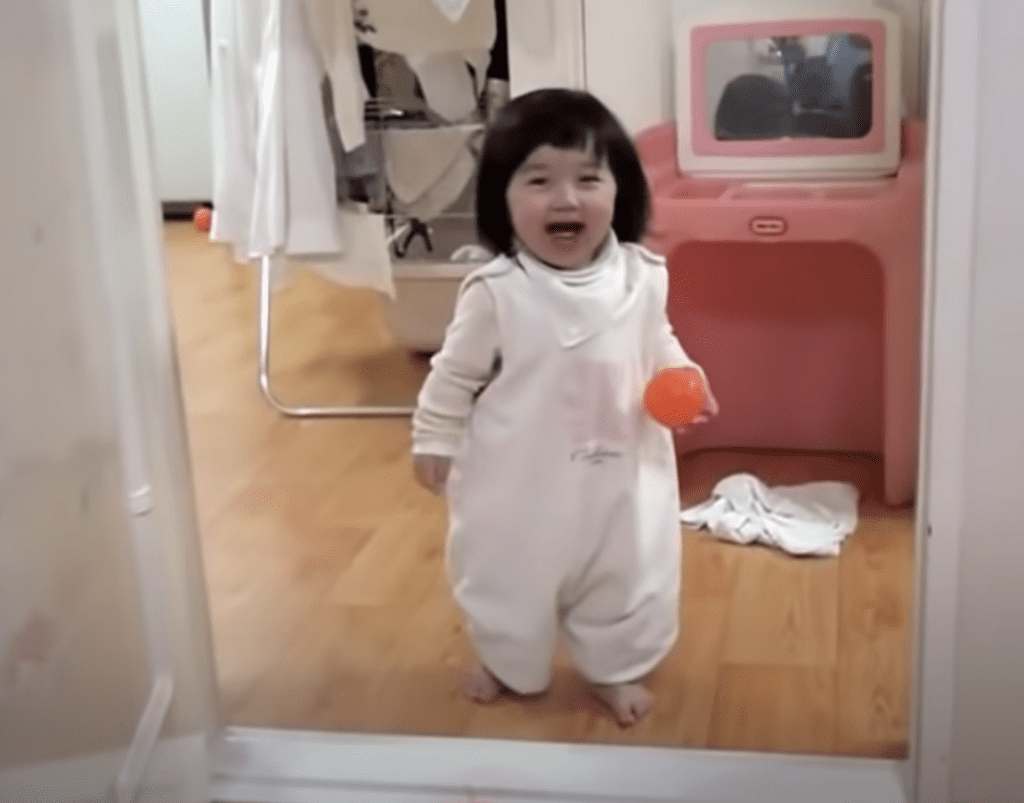Funny baby girl turns the tables on dad during playtime