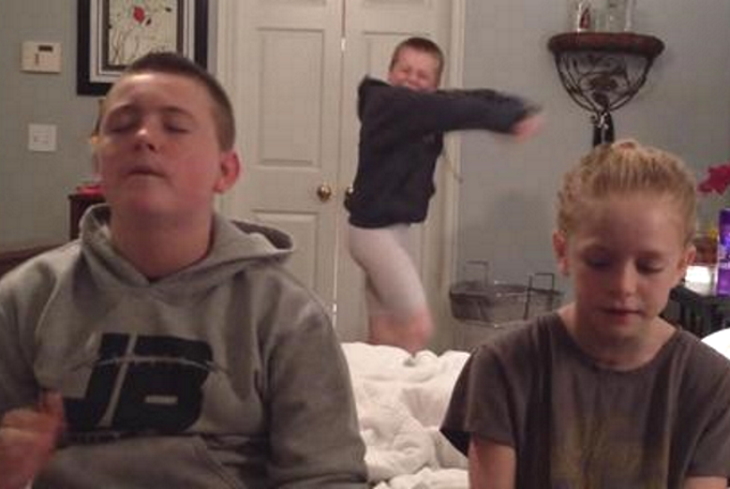 Kids are in middle of singing for camera unaware little brother ...
