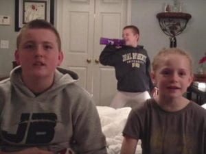 Kids are in middle of singing for camera unaware little brother ...