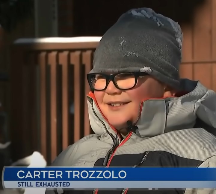 Exhausted kid wins hearts with his funny reaction to shoveling snow